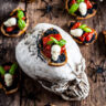 Spooky Skull Caprese Crostini - Dish 'n' the Kitchen